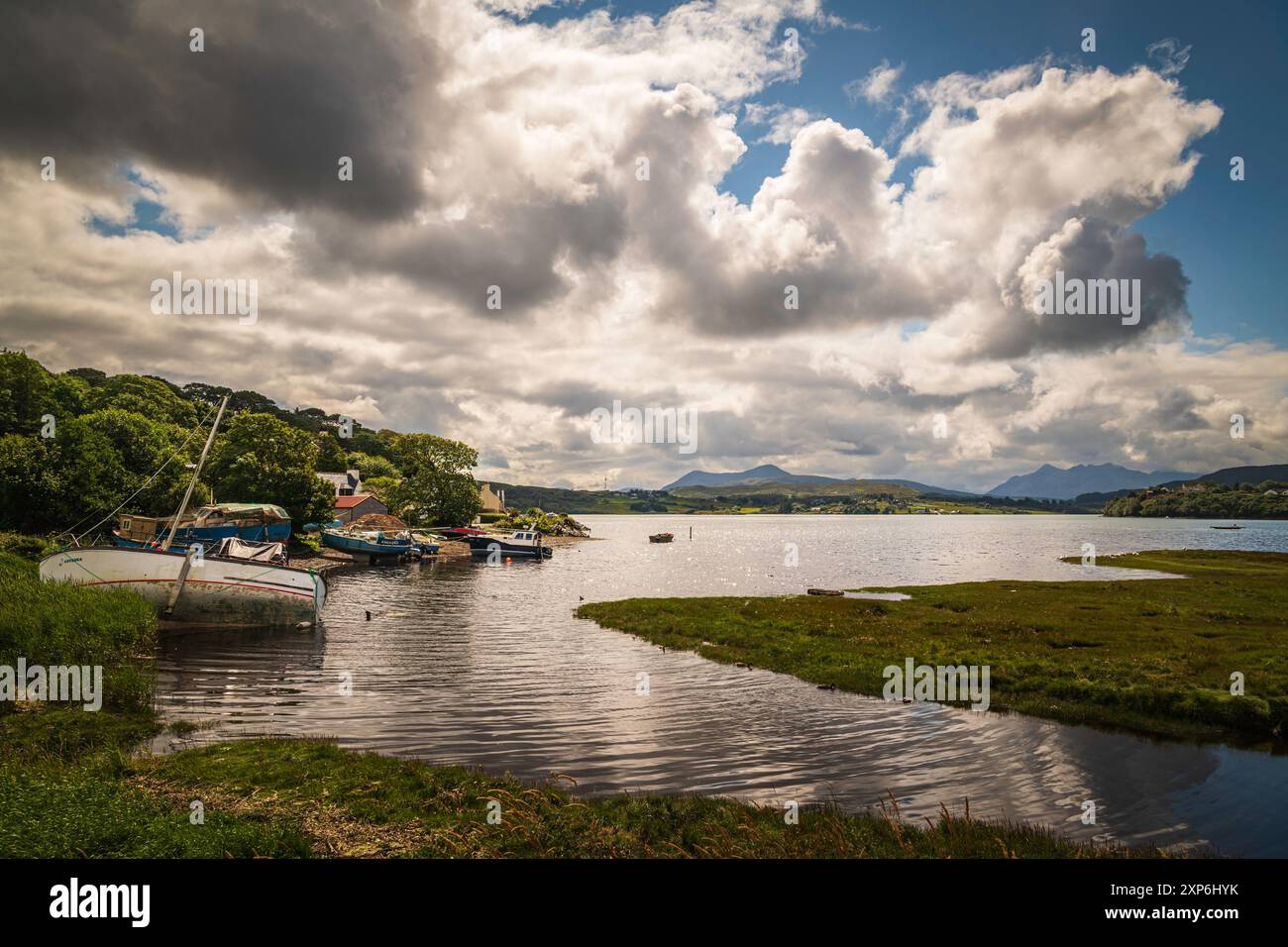 A gloomy summer HDR image of a small boatyard, with eight boats, in ...