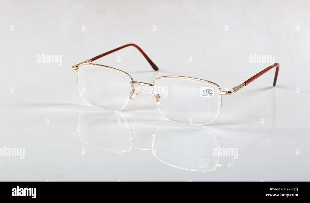 Medicine and optic - Modern gold reading Glasses white background and ...