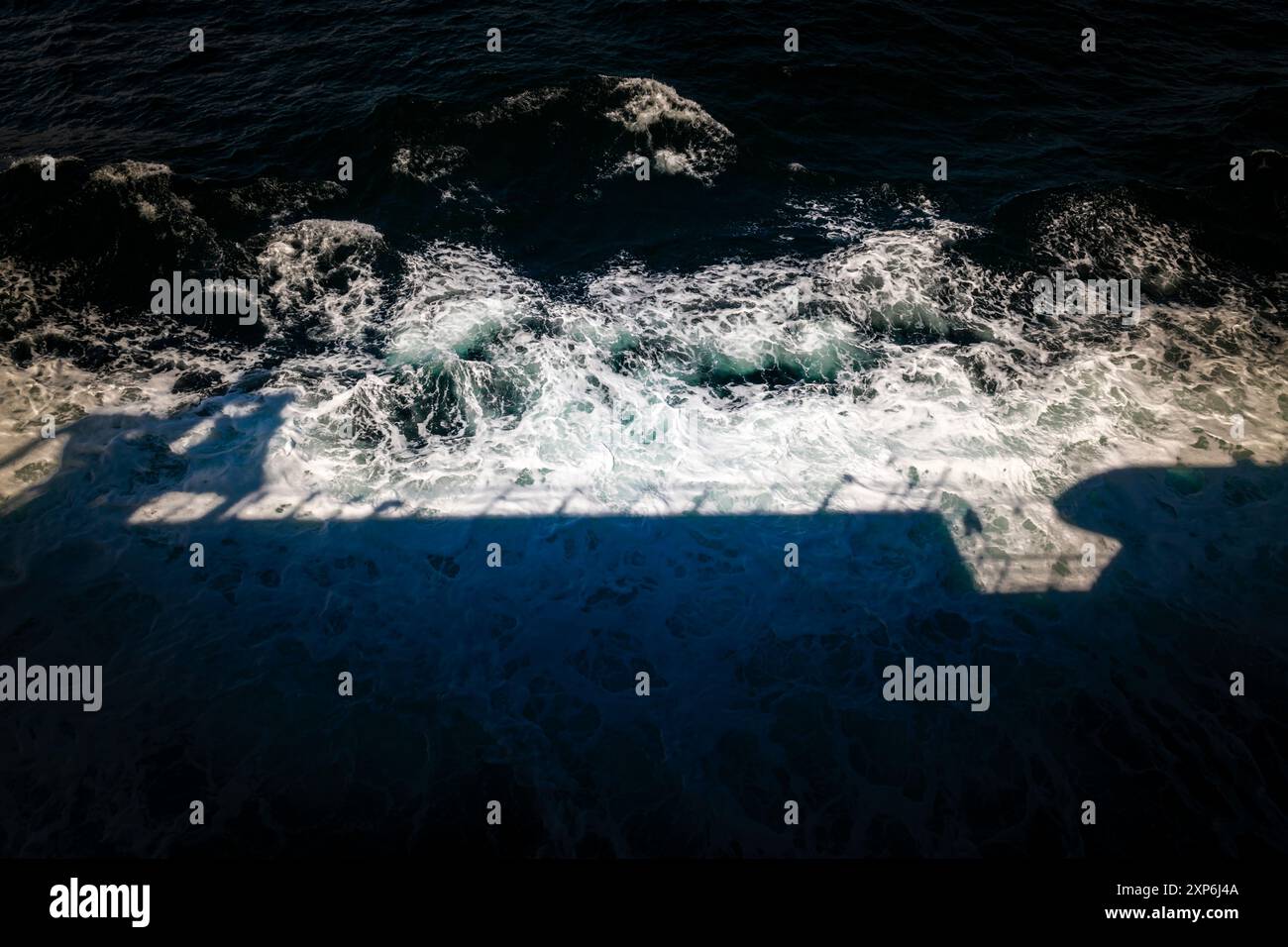 A summer HDR image of the cast shadow of a scottish ferry on the ...