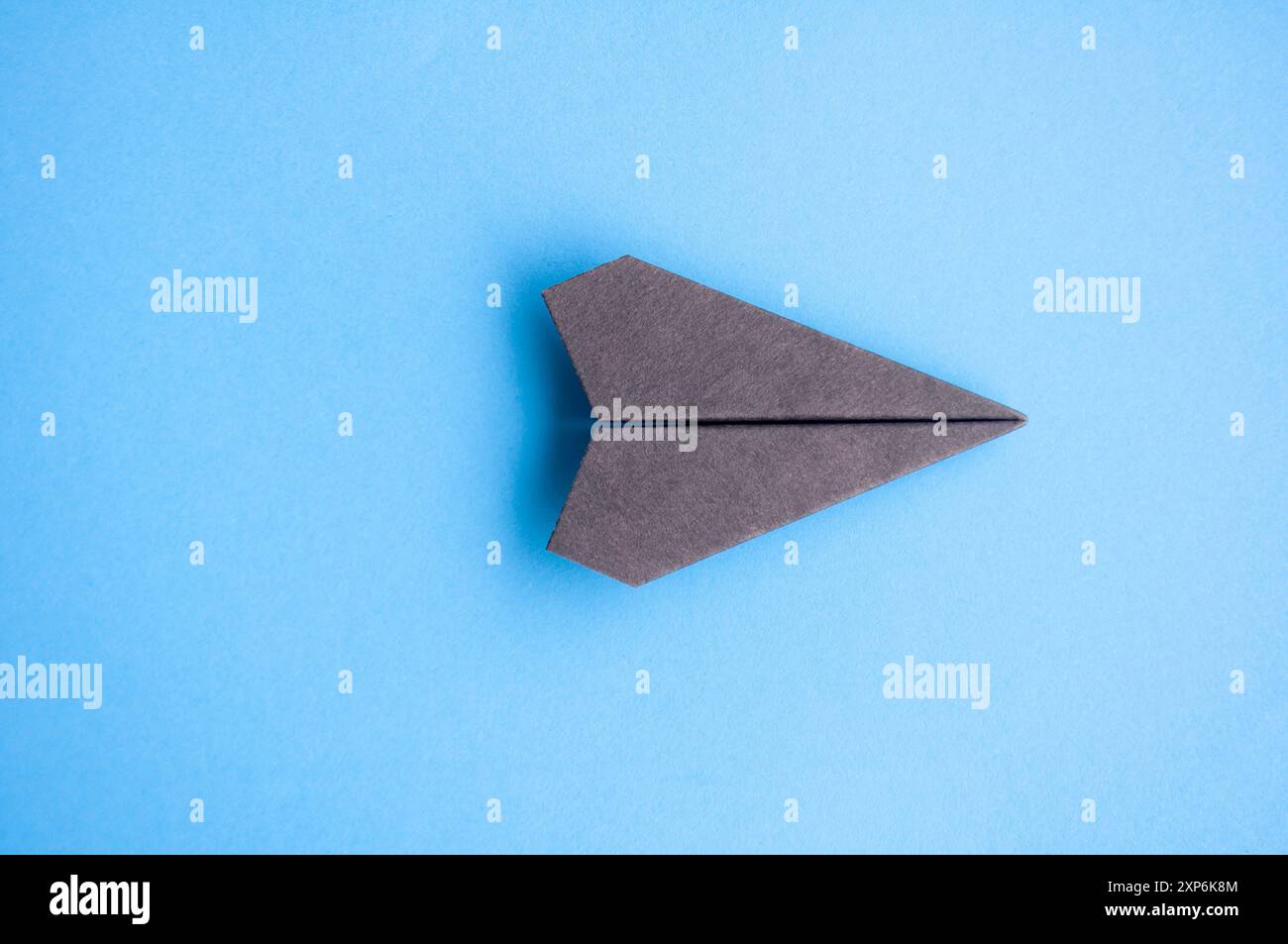 Top view of black paper airplane with customizable space for text or ...