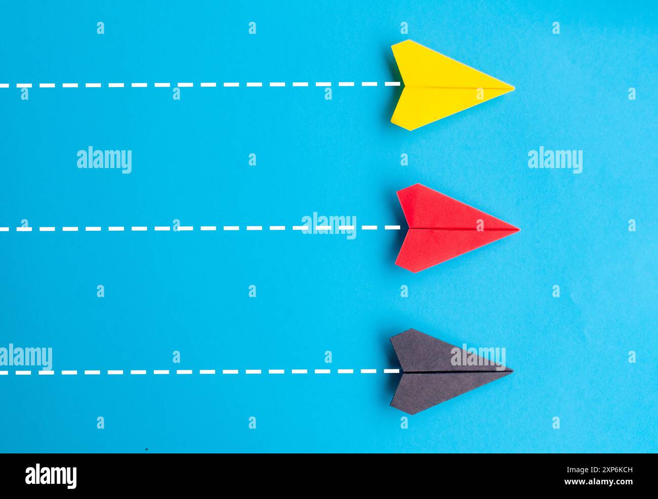 Close up view of multicolored paper airplane on blue background ...