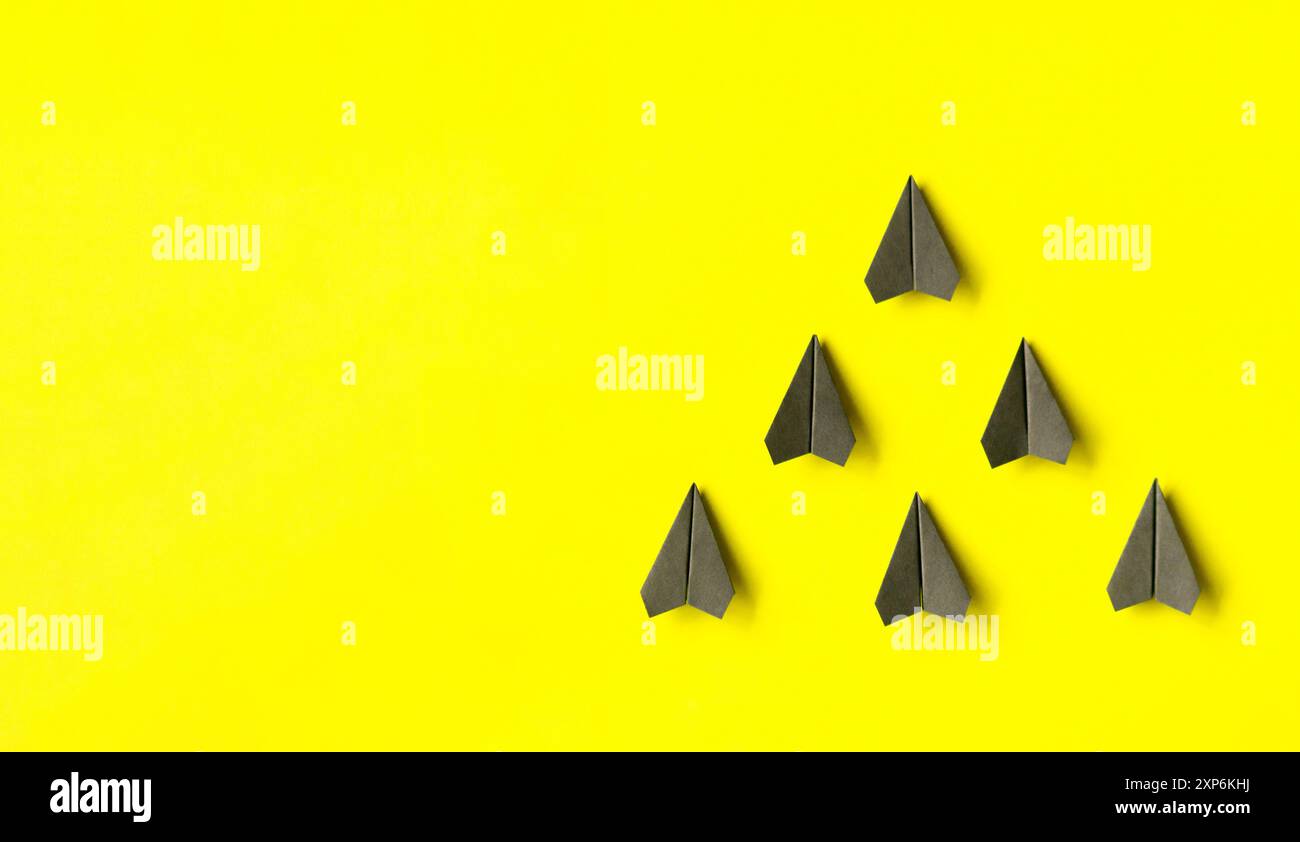 Black paper airplane origami leading the rest of the airplanes on ...