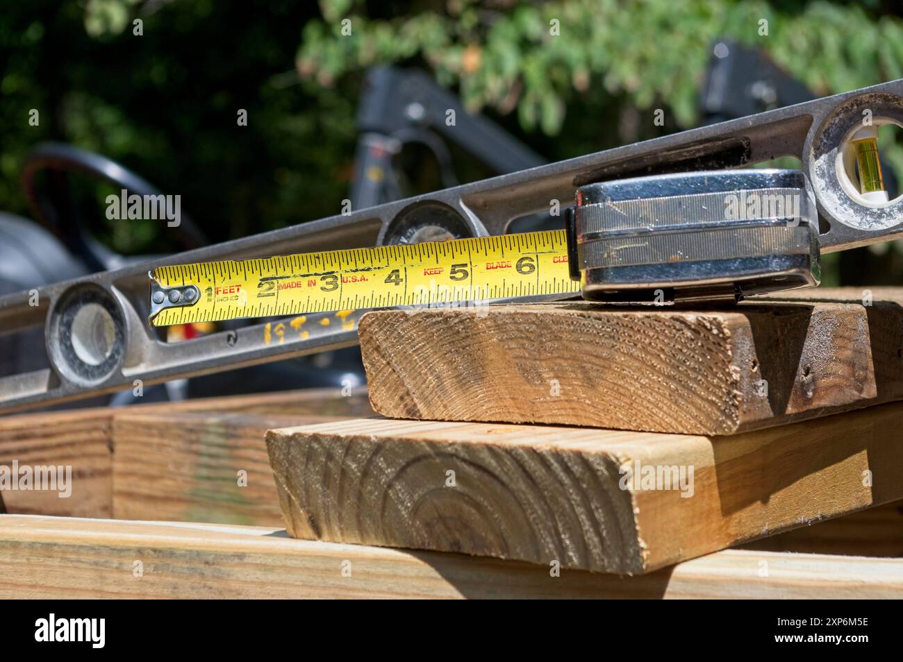 Measuring tape and a bubble level at a job site Stock Photo - Alamy
