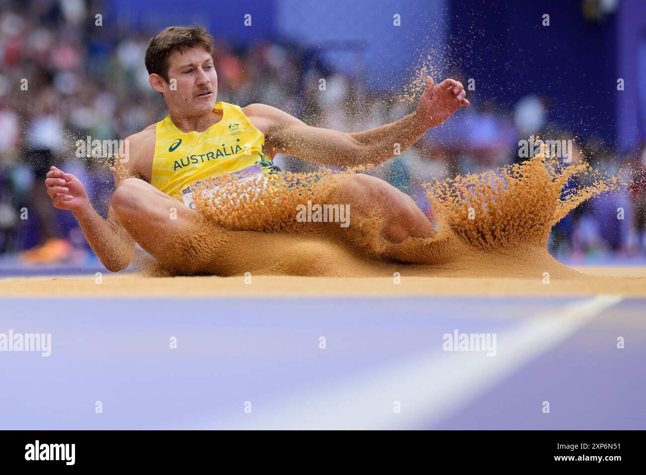 Liam Adcock, of Australia, competes in the men's long jump ...