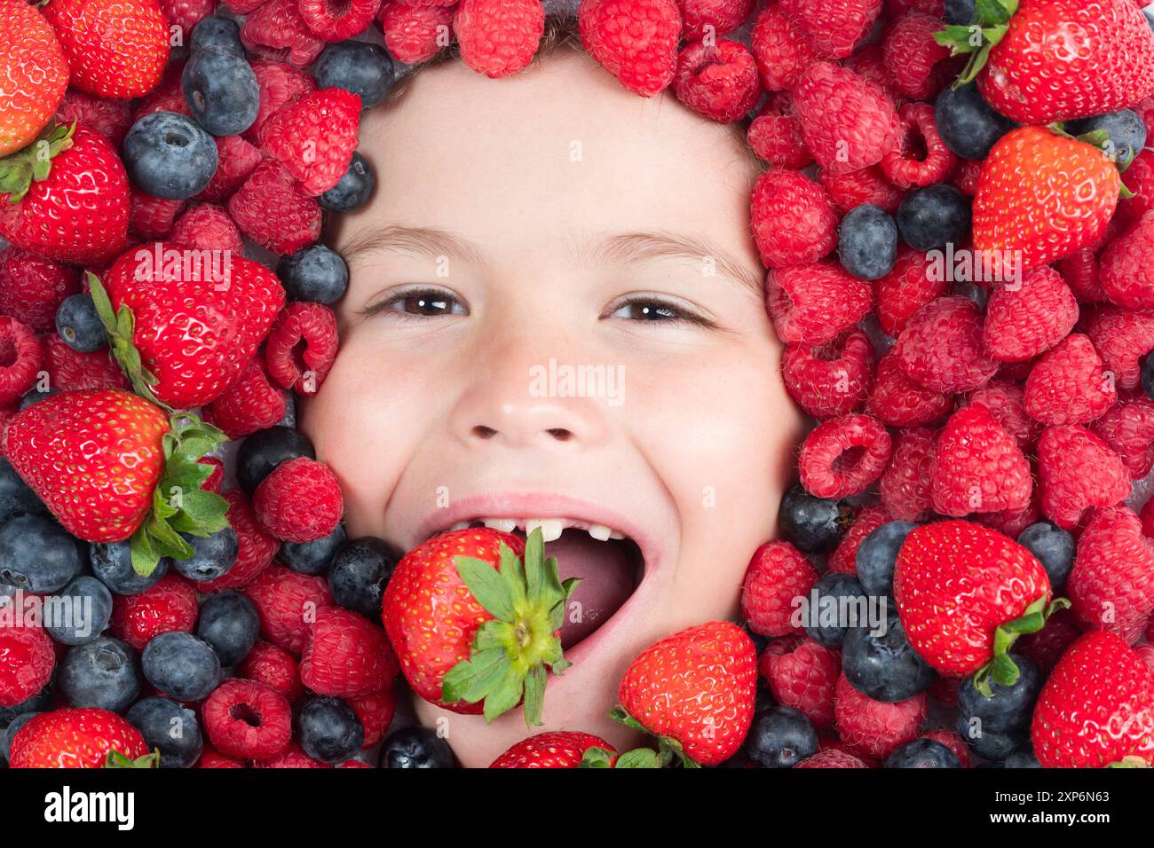 Fruits for kids. Berries child face close up. Top view photo of child ...