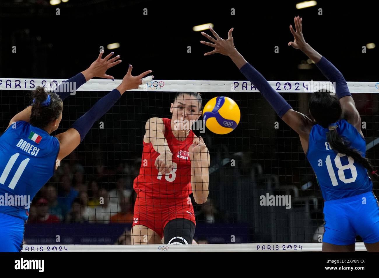 Zehra Gunes of Turkey, center, spikes the ball against Turkey during ...