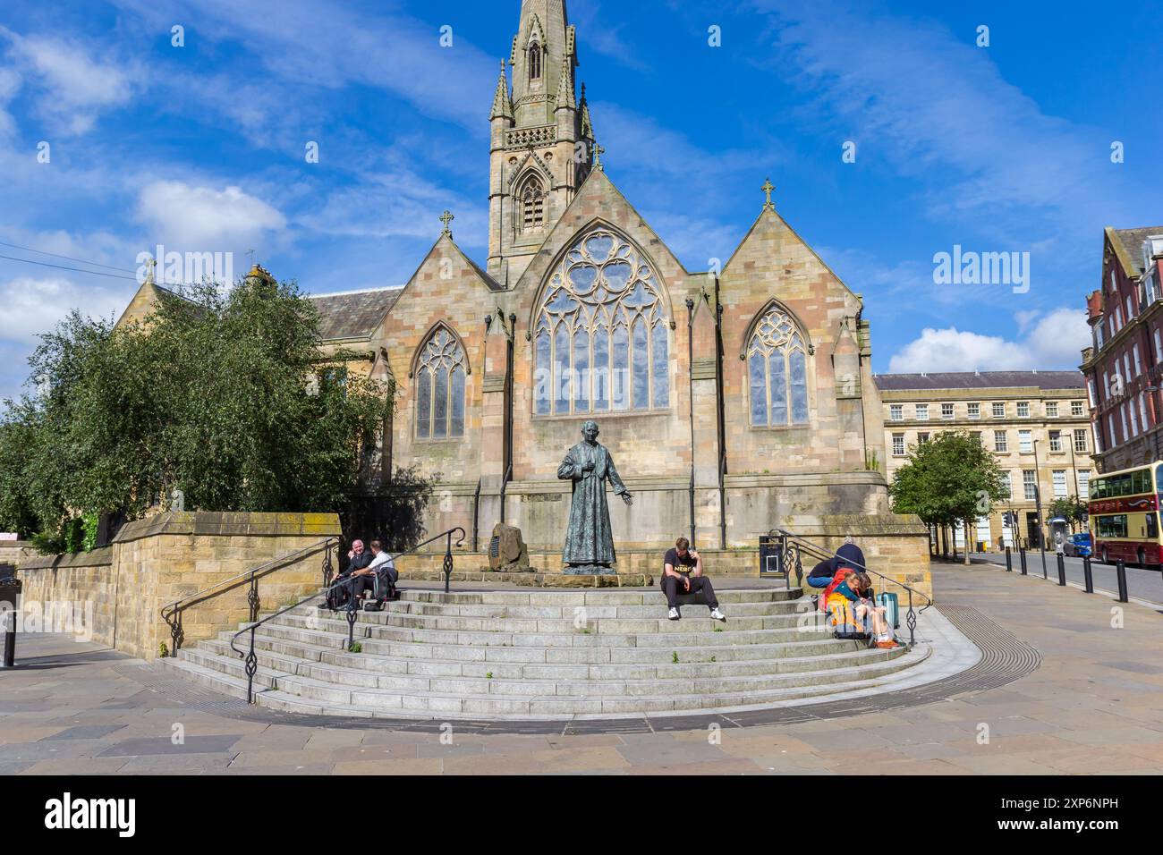 People sitting on the steps in front of the cathedral in Newcastle upon ...
