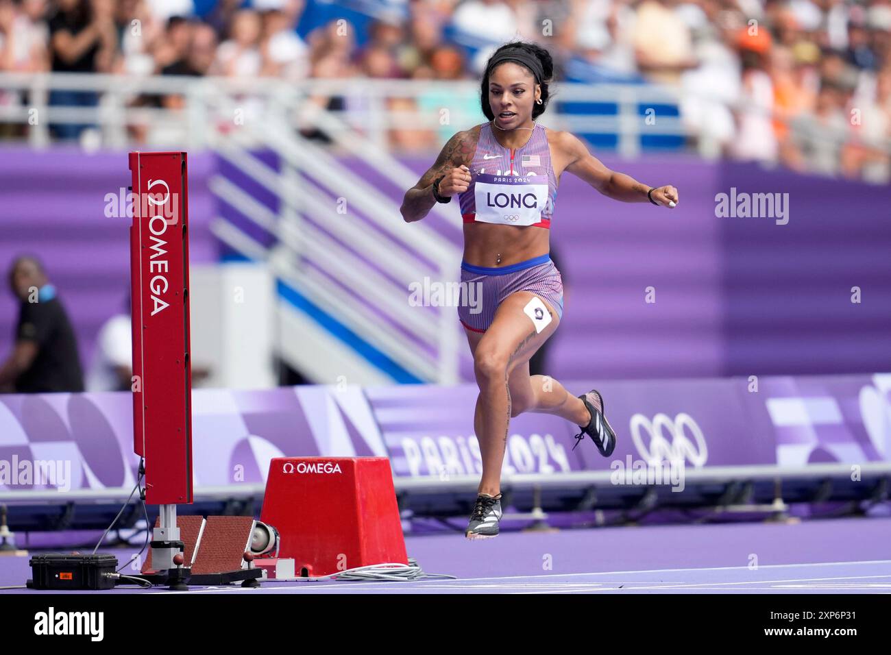 McKenzie Long, of the United States crosses the finish line in a women ...