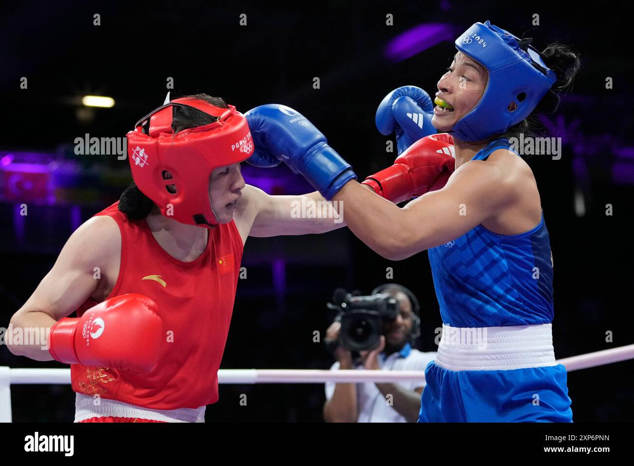 China's Li Qian hits India's Lovlina Borgohain in their women's 75 kg quarterfinal boxing match ...