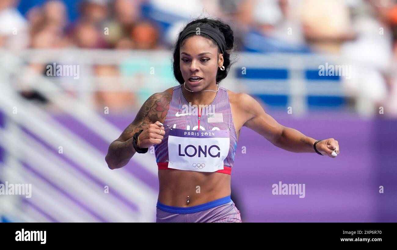 McKenzie Long, of the United States crosses the finish line in a women ...