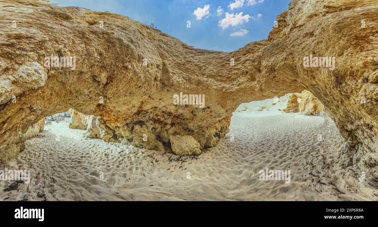 Two large sandstone formations in a dark cave at the bottom of an arid ...