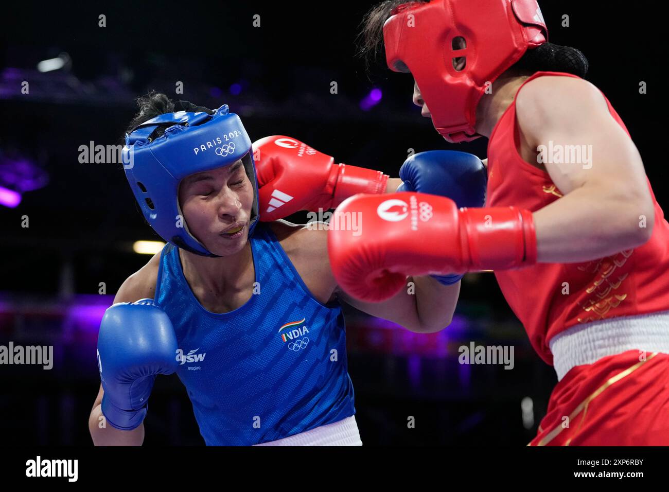 China's Li Qian, right, fights India's Lovlina Borgohain in their women's 75 kg quarterfinal ...