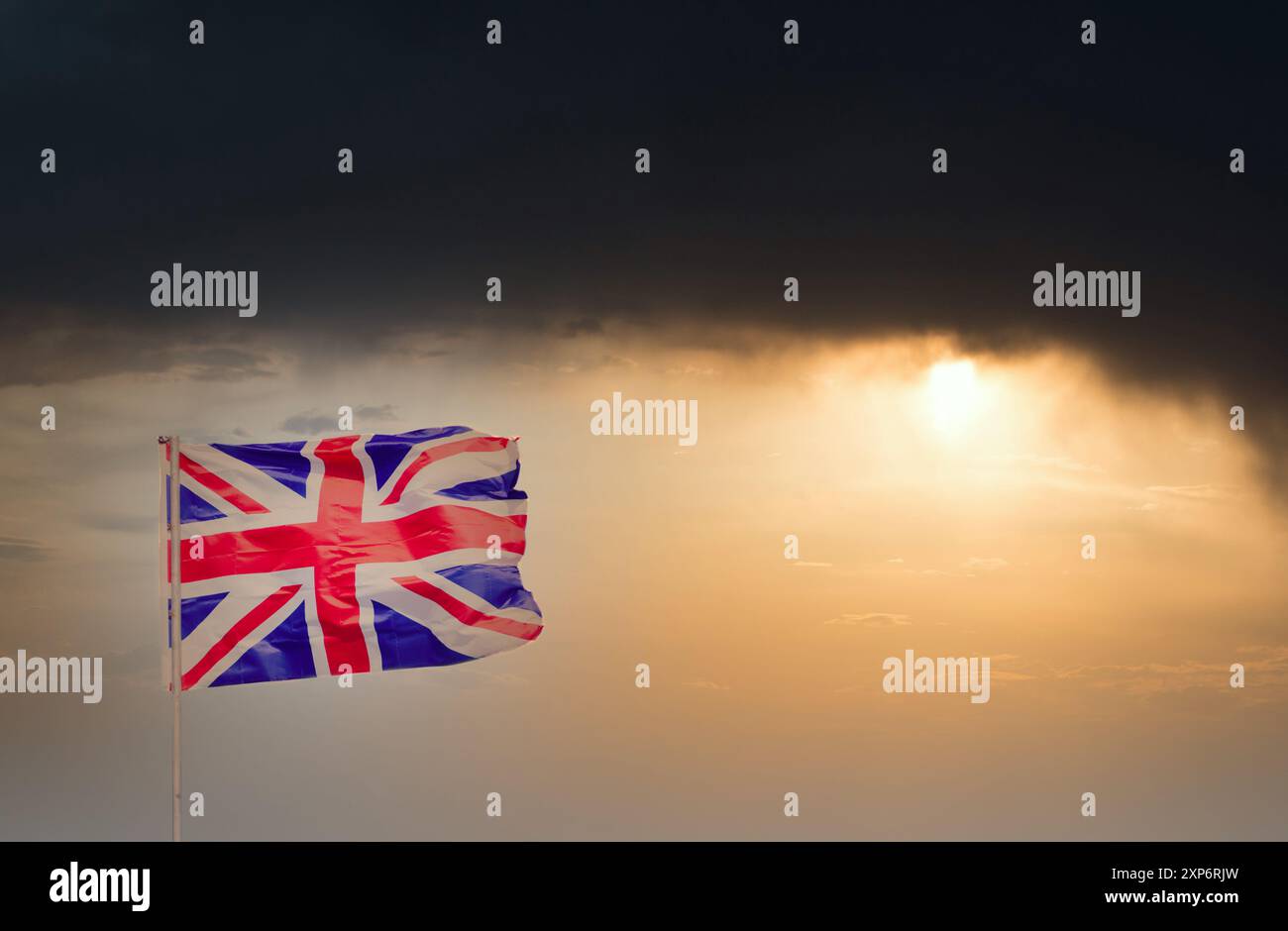 Union Jack British flag suspended high in sky Stock Photo - Alamy
