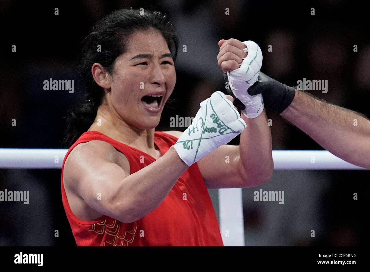 China's Li Qian celebrates after defeating India's Lovlina Borgohain in ...
