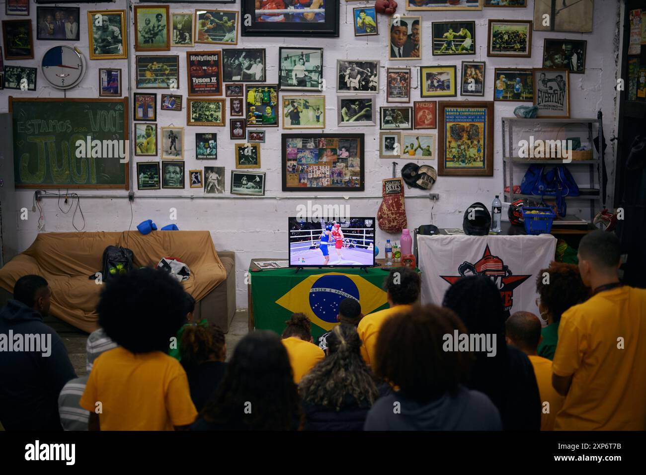 Fans watch on TV the fight between Brazilian boxer Jucielen Cerqueira ...