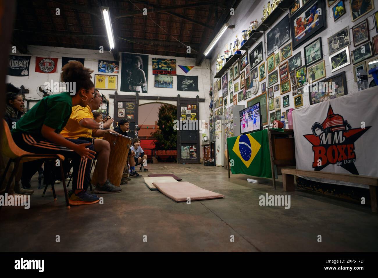 Fans watch on TV the fight between Brazilian boxer Jucielen Cerqueira ...