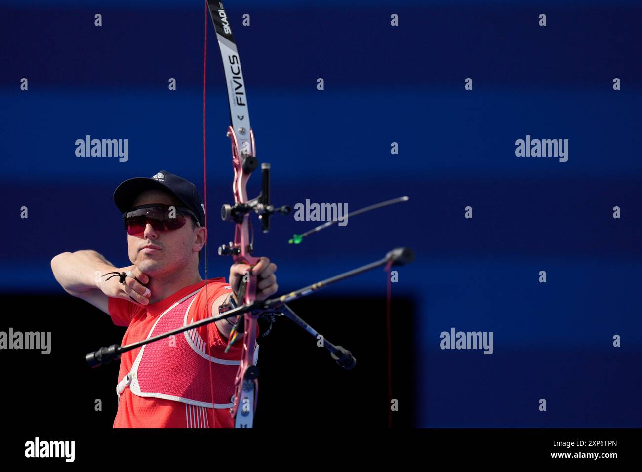 Britain's Tom Hall shoots during the Archery individual quarterfinal ...