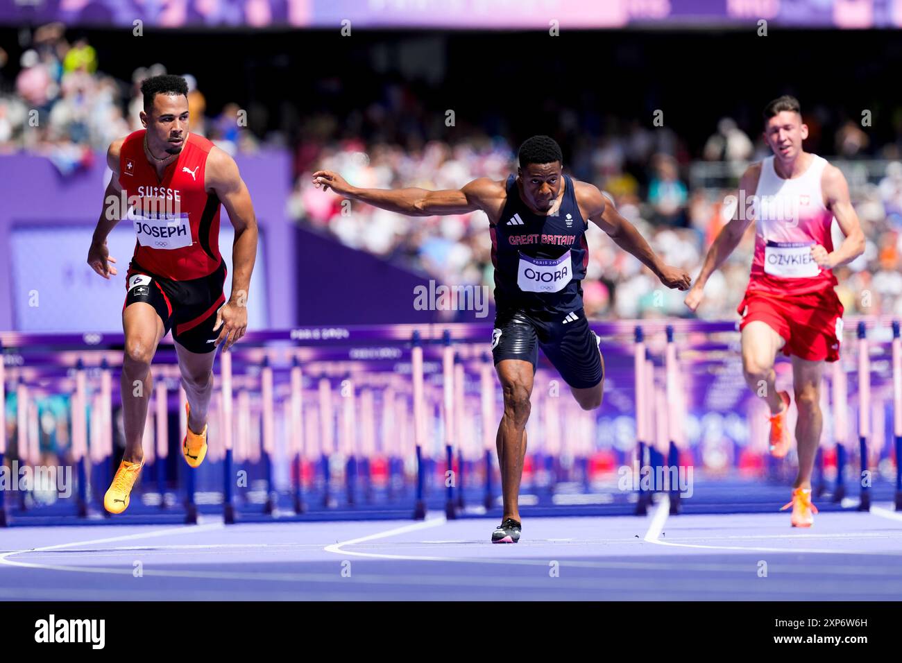 Jason Joseph, left, of Switzerland, wins a heat in the men's 110-meter ...