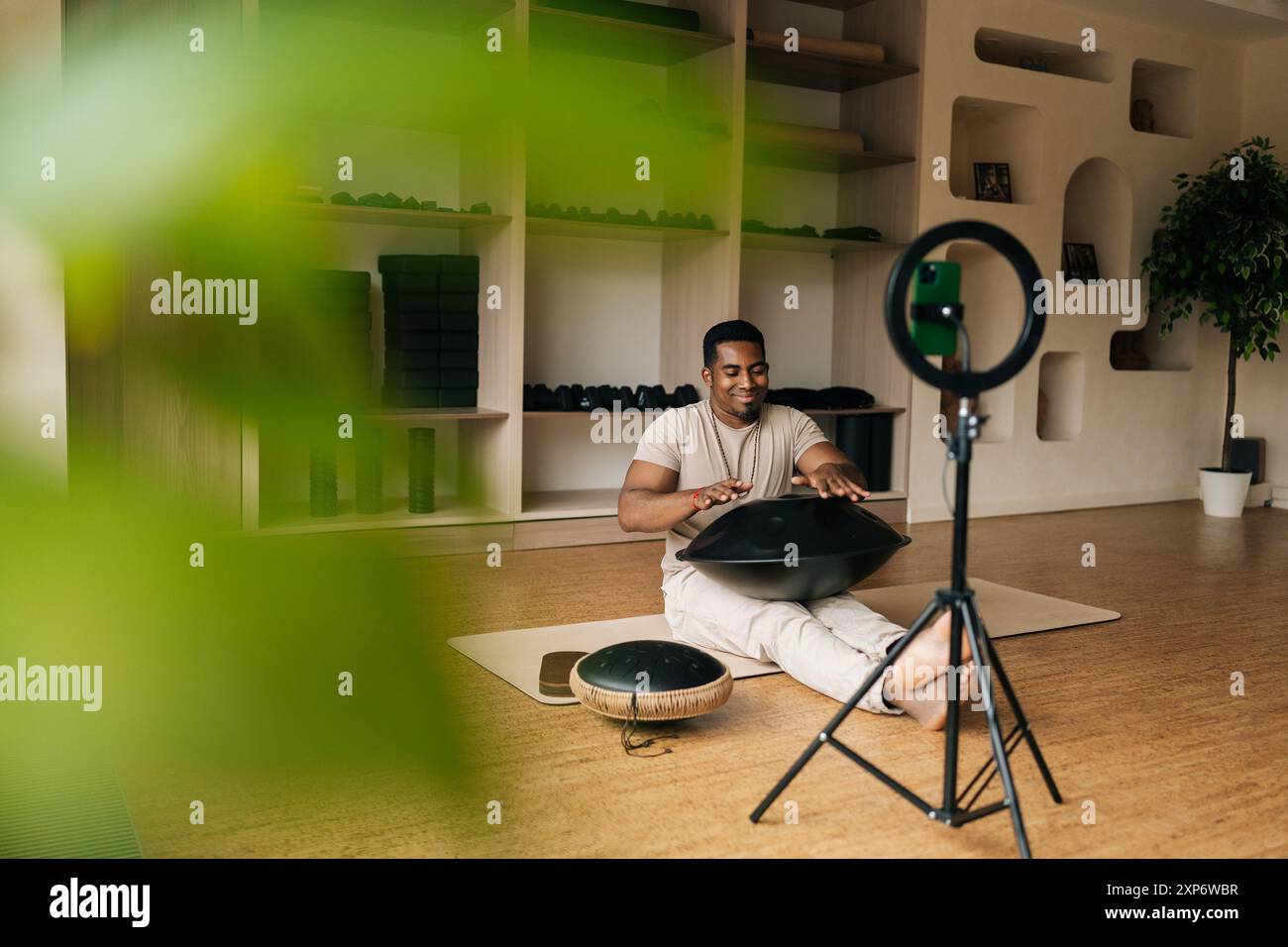 Happy smiling black male blogger practicing native music traditional ...