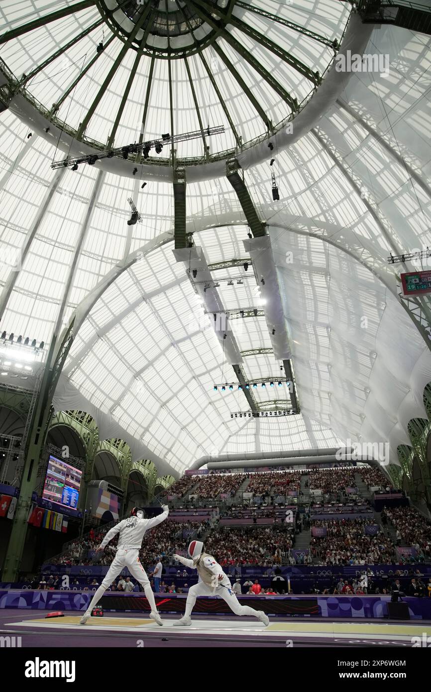 China's Xu Jie competes with France's Maxime Pauty in the men's team ...