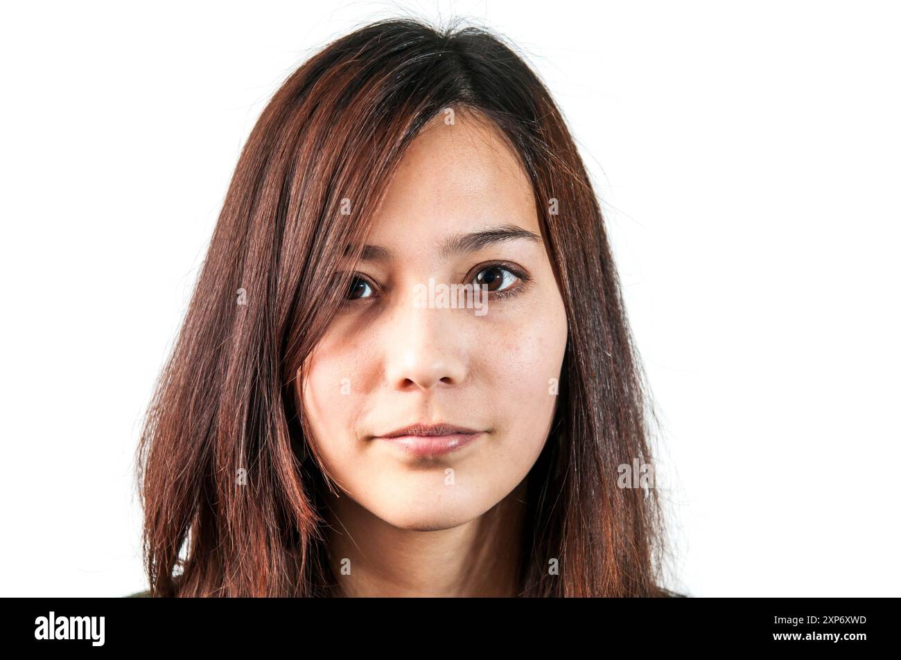 Head portrait of a young Asian woman looking directly into the camera ...