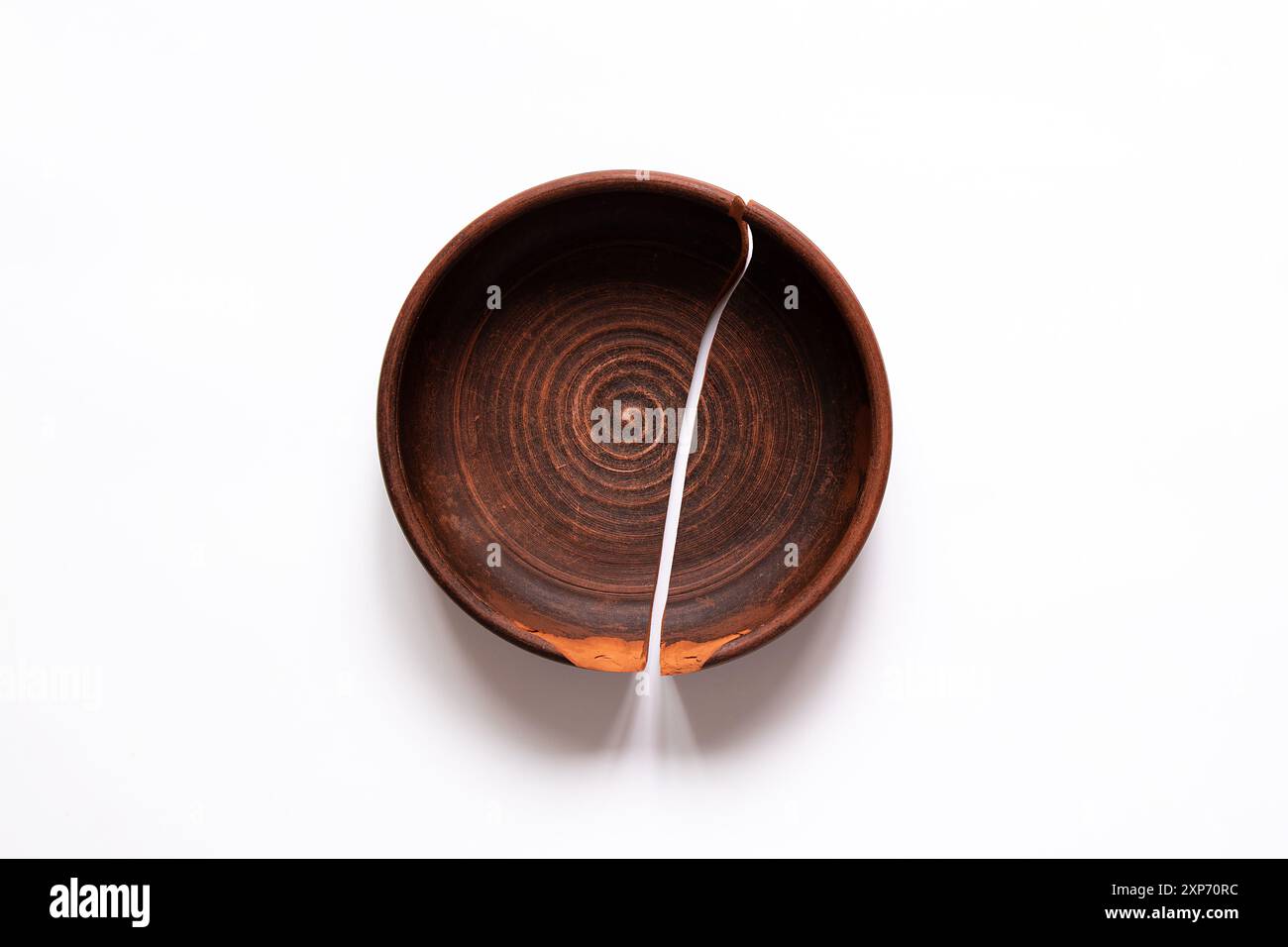 Broken brown clay plate on white background, broken dishes Stock Photo ...