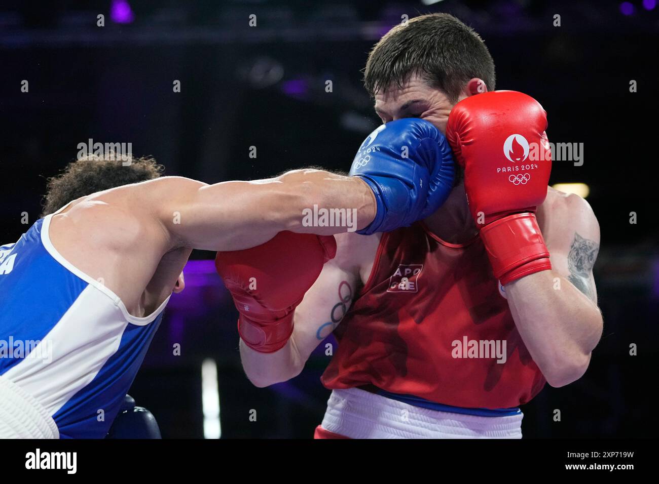 France's Sofiane Oumiha, left, hits Canada's Wyatt Sanford in their men ...