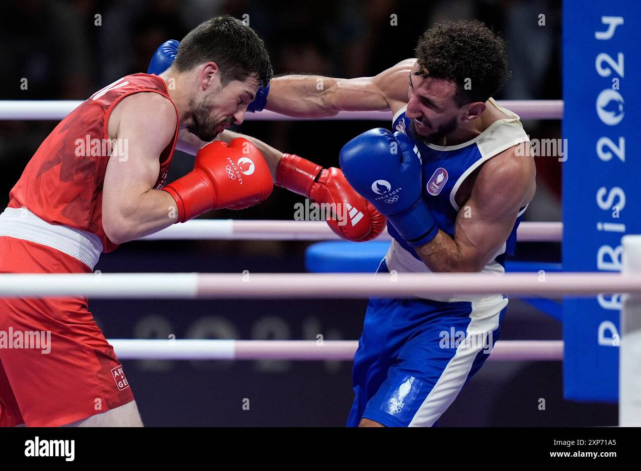 France's Sofiane Oumiha, right, hits Canada's Wyatt Sanford in their ...