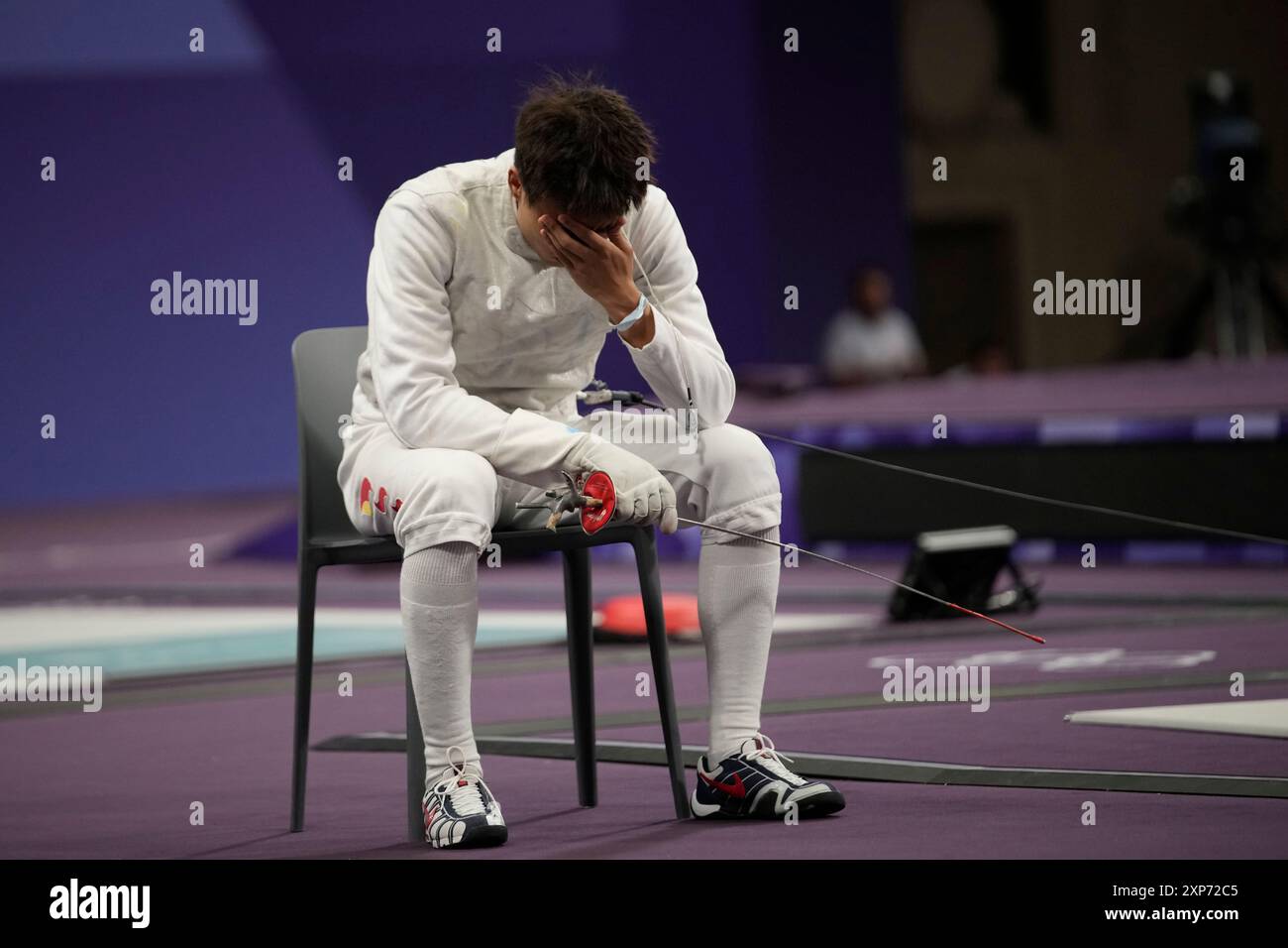 CORRECTS MATCH DETAILS China's Mo Ziwei reacts after losing the men's ...