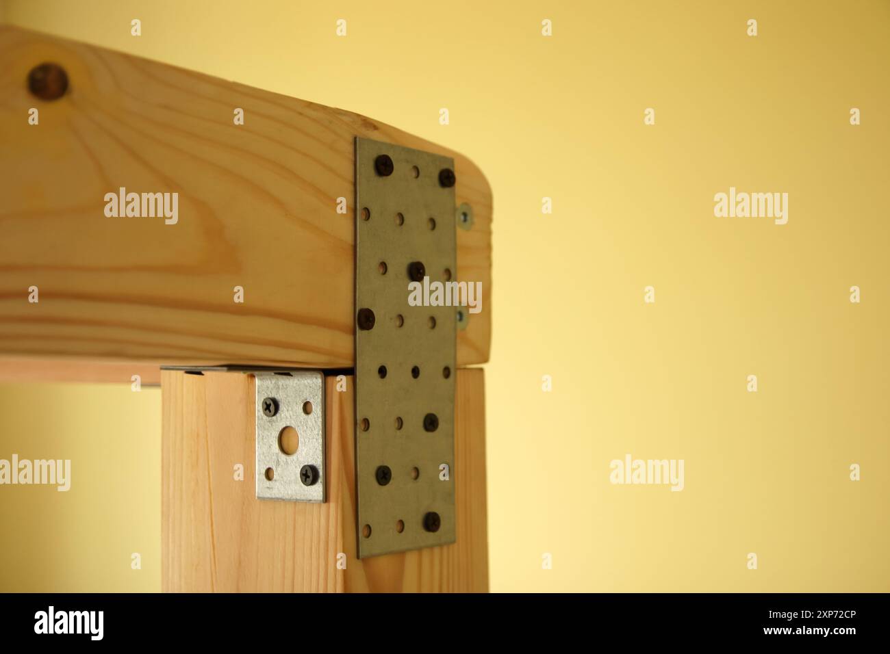 Wooden beam with iron fastening, close-up of bed frame construction ...