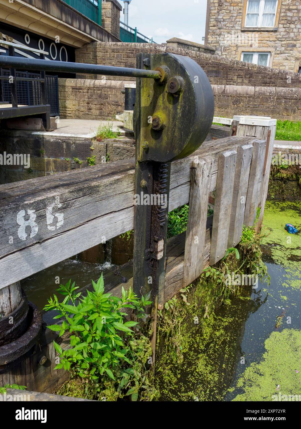 Old canal lock mechanism with weathered wood and moss, captured on a ...