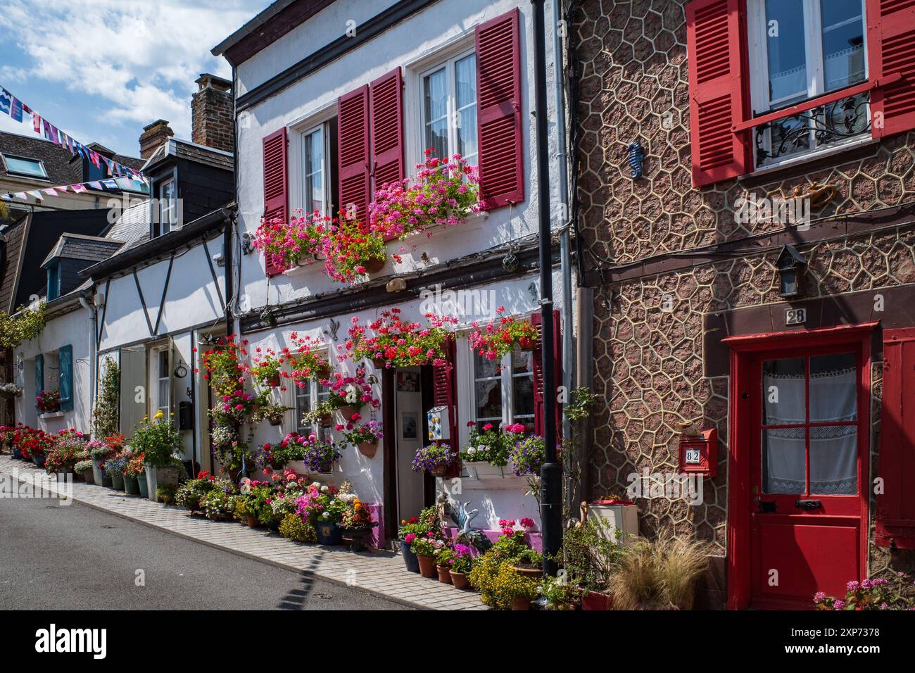 Picturesque cottages with vibrant flower displays outside in Saint ...