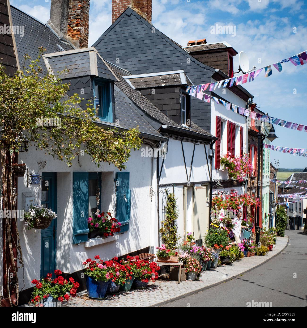 Picturesque cottages with vibrant flower displays outside in Saint ...