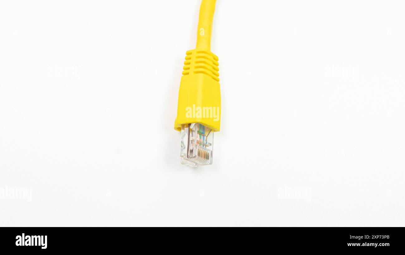 A yellow internet cables with a white background Stock Photo - Alamy