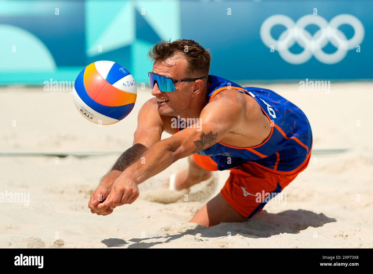 Netherland's Yorick de Groot returns a shot in a beach volleyball match ...