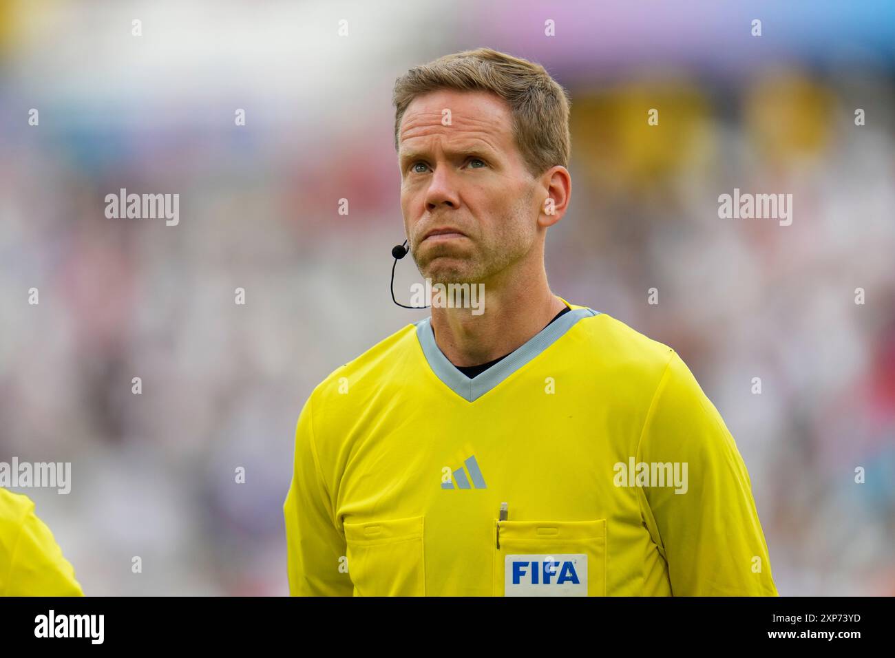 Fourth official Drew Fischer, of Canada, participates in a men's ...