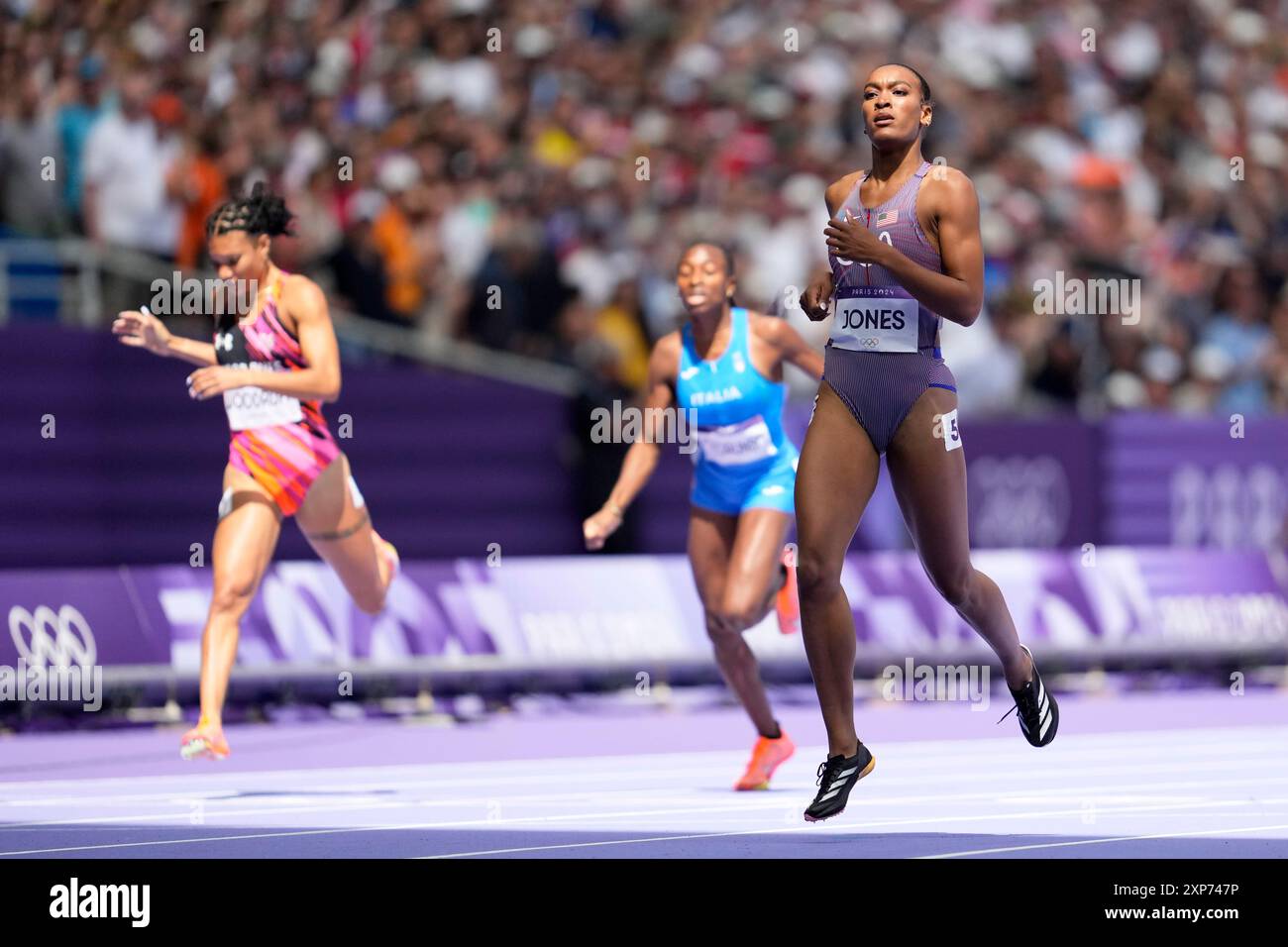 Jasmine Jones, of the United States, crosses the finish line to qualify ...