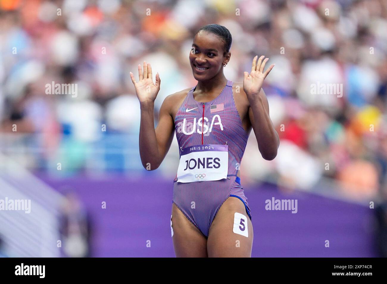 Jasmine Jones, of the United States, waves after crossing the finish ...