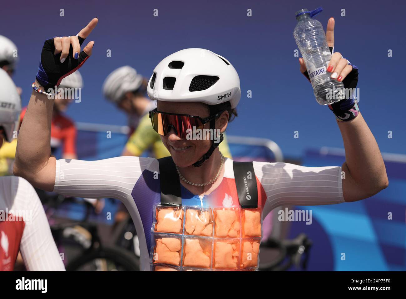 Audrey Cordon Ragot, of France, waves ahead of the women's road cycling ...