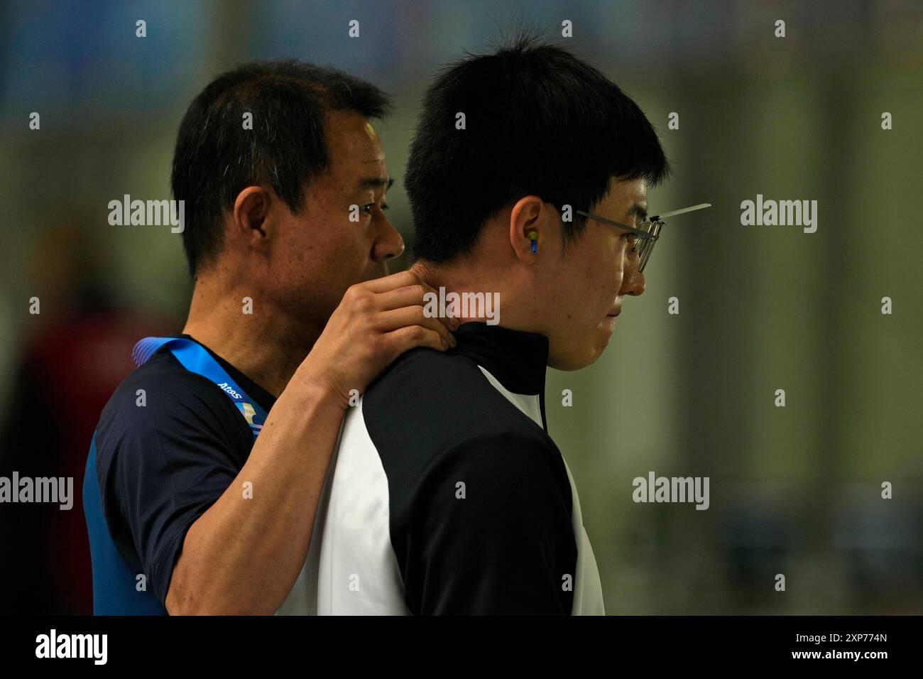 South Korea's Cho Yeong-Jae, right, gets a neck massage from his coach ...