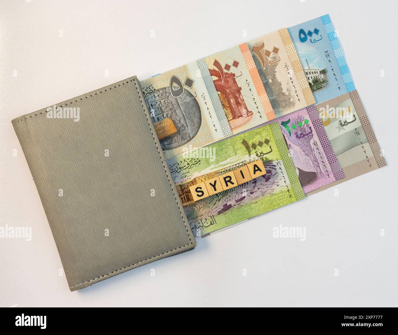 Syrian lira currency notes with a note book isolated on white ...