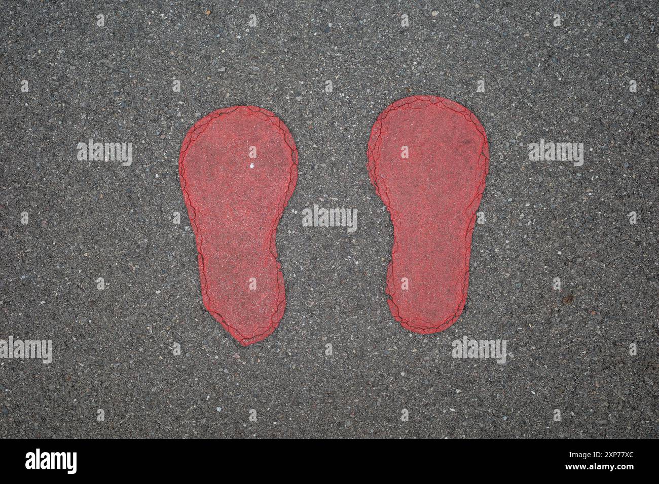 Red footprints painted on the ground Stock Photo - Alamy