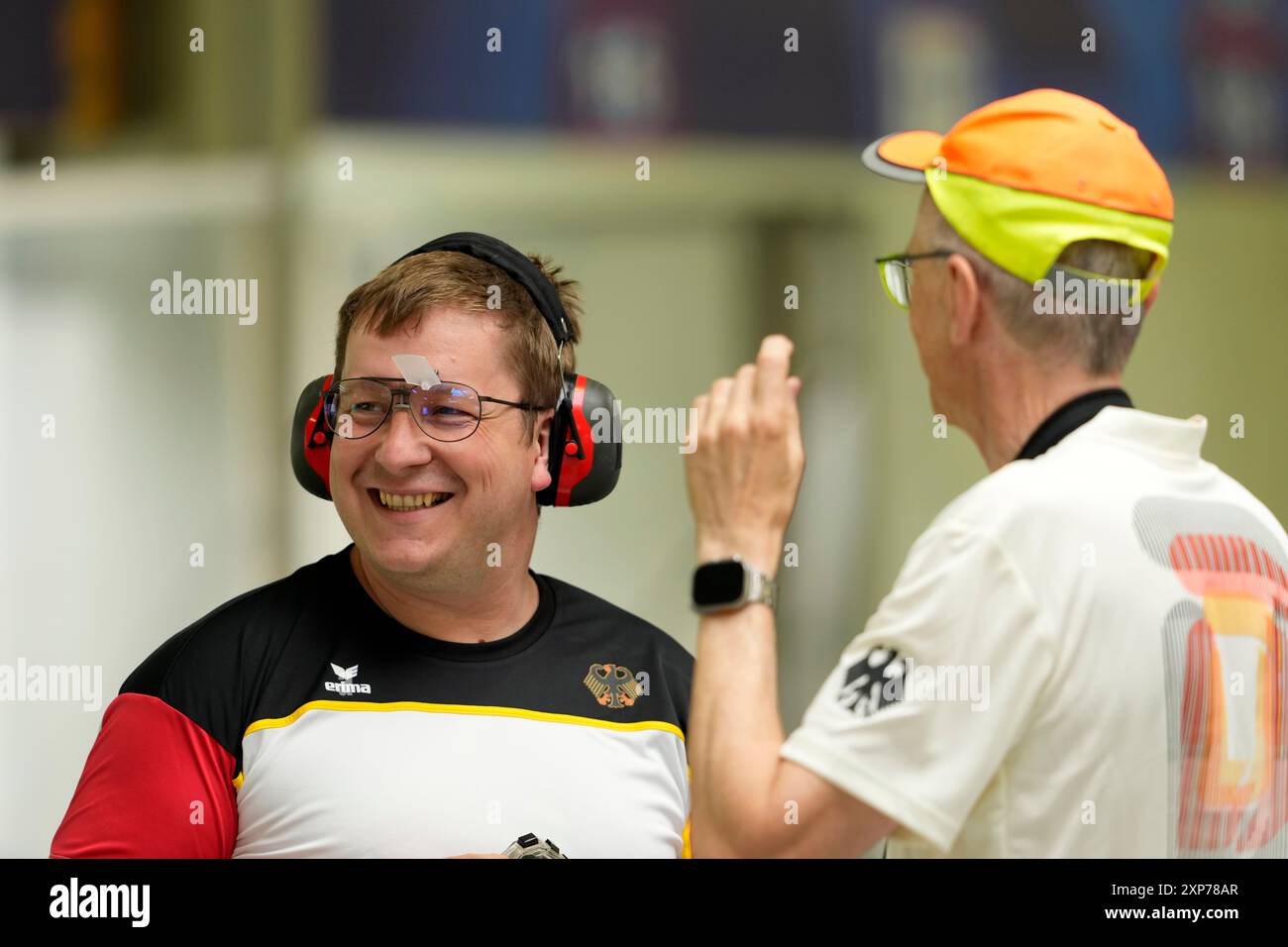 Germany's Christian Reitz, left, chats with his coach as he competes in ...