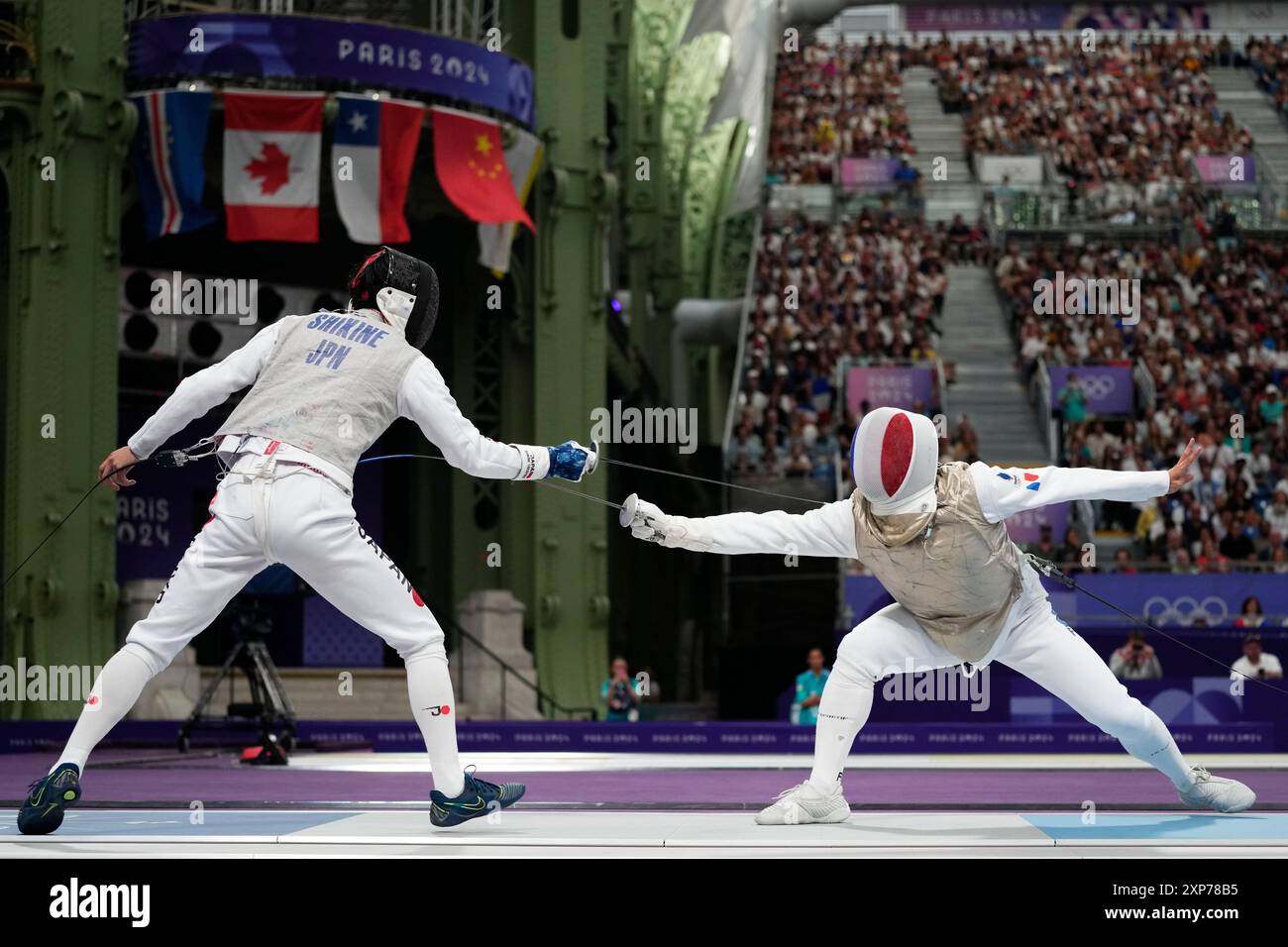 Japan's Takahiro Shikine competes with France's Maxime Pauty in the men ...