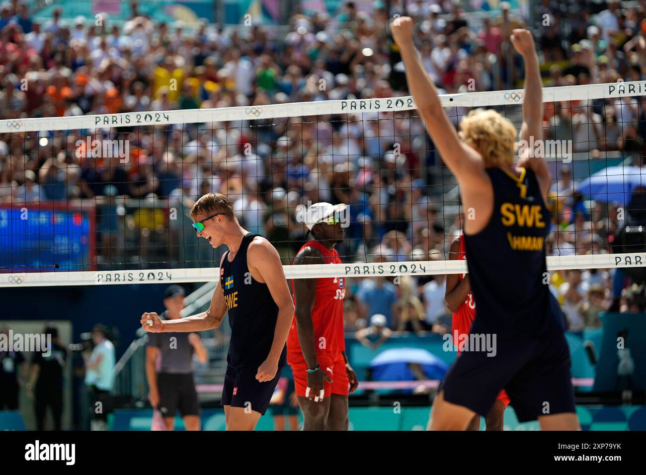 Sweden's Jonatan Hellvig, left, celebrates in a beach volleyball match ...