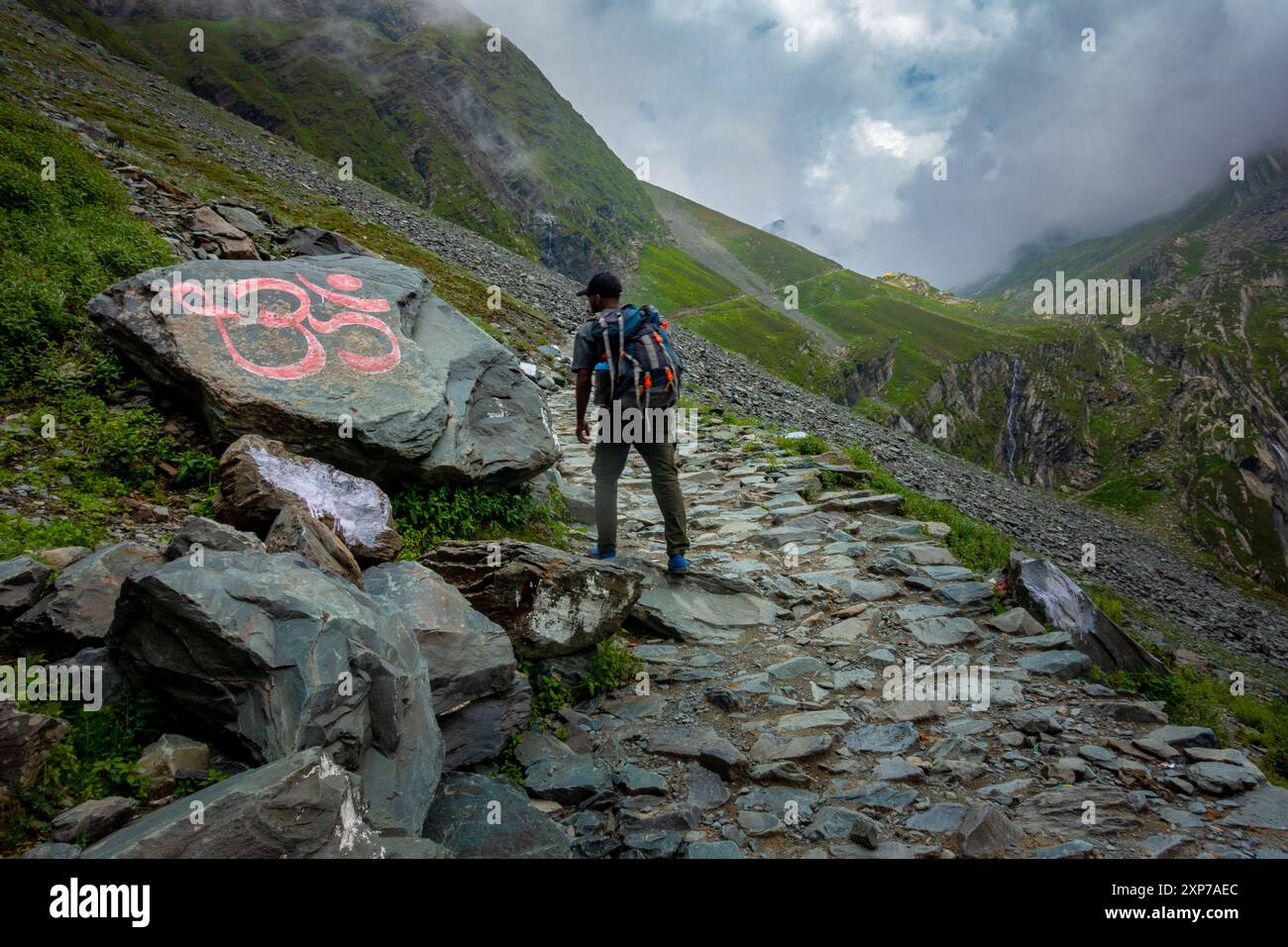 July25th2024, Himachal Pradesh, India. A devotee passing by an Om sign ...