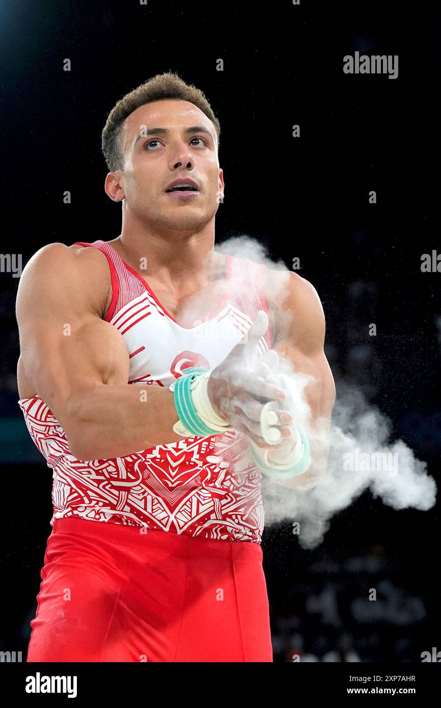 Adem Asil, of Turkey, rubs powder on his hands as he prepares to ...