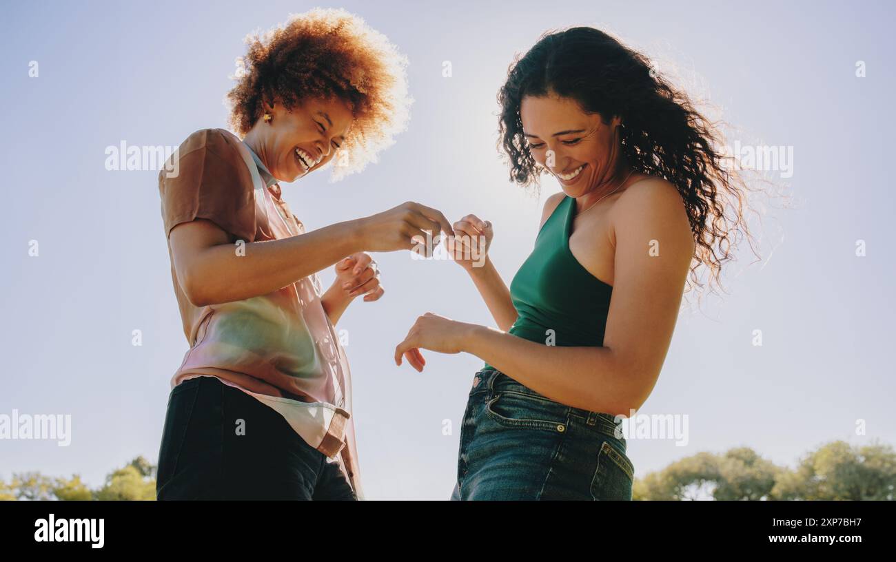 Young best friends having fun outdoors, sharing laughter and joy under ...