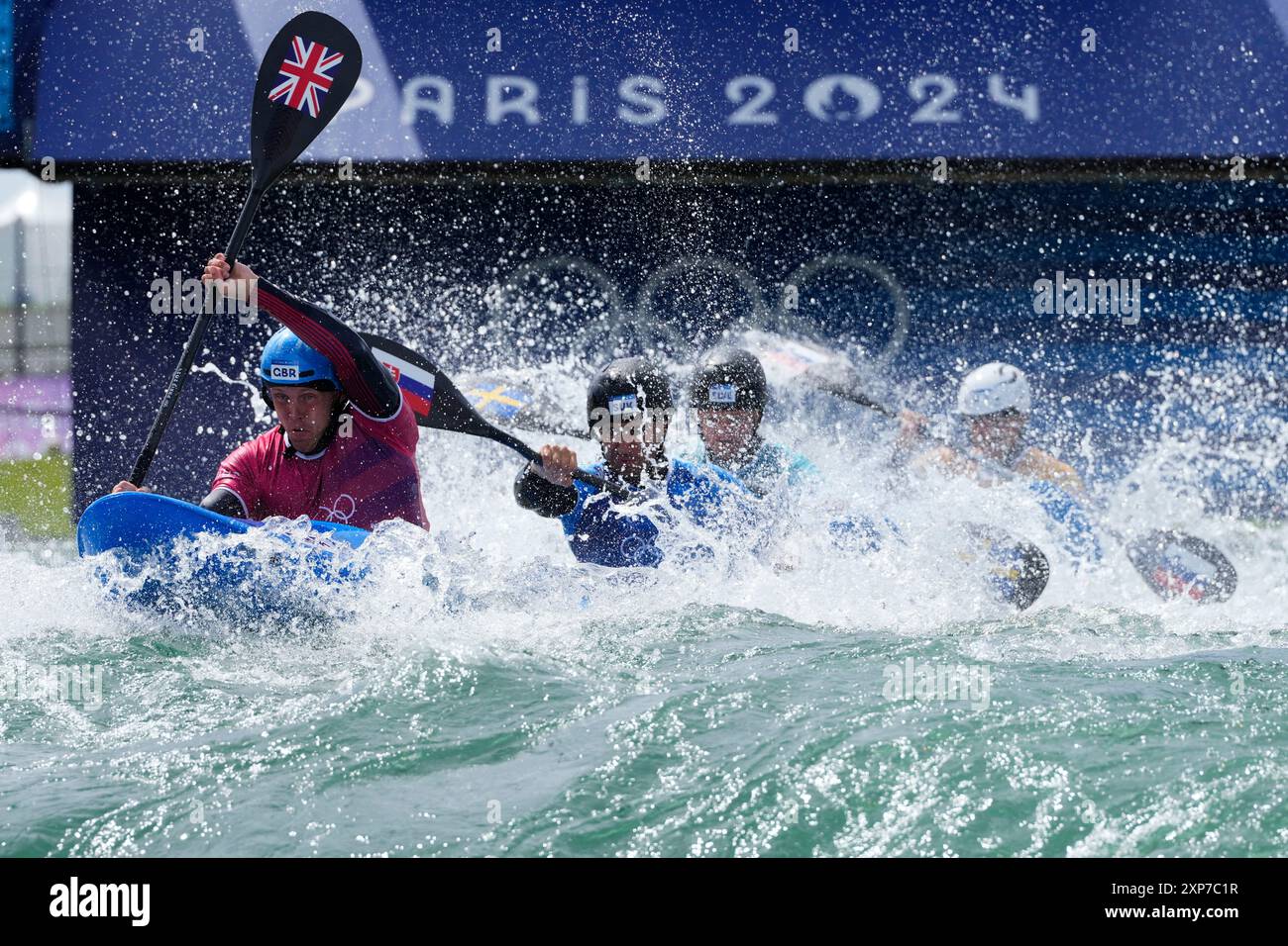 Joseph Clarke of Britain competes in the men's kayak cross heat against ...