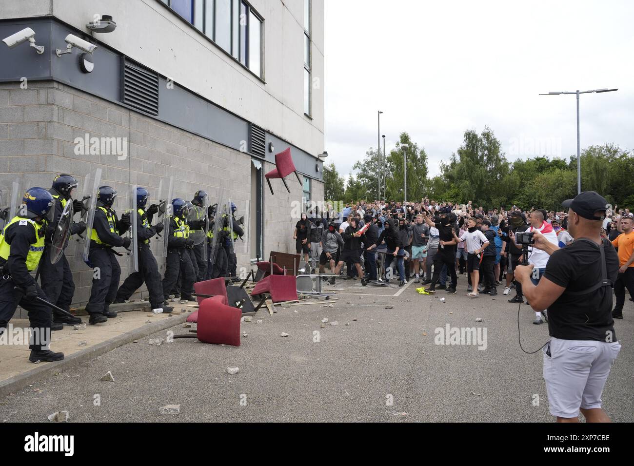 A chair is thrown at police officers as trouble flares during an anti ...